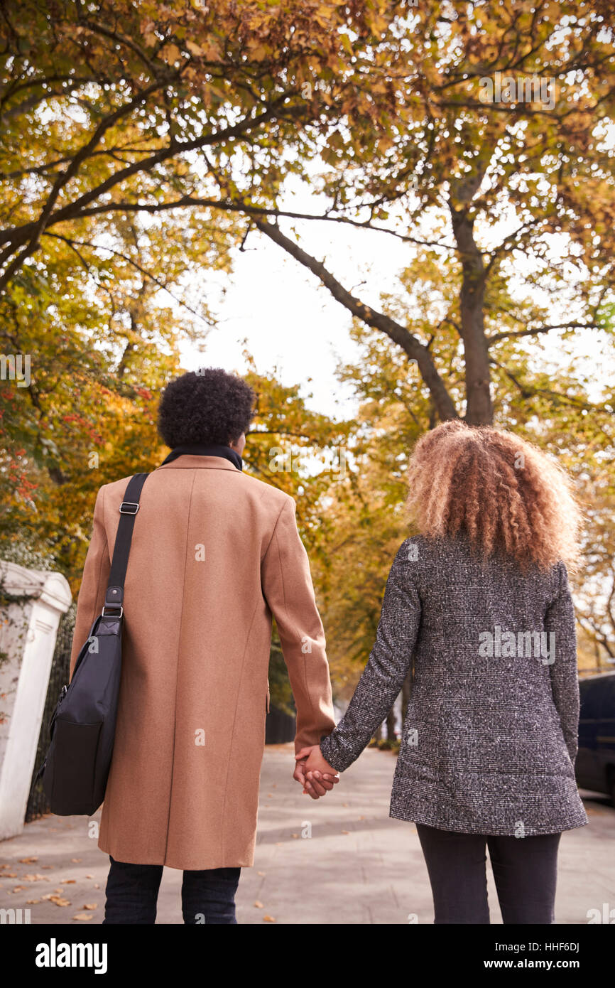 Rear View Of Romantic Couple Walking On Fall Street In City Stock Photo ...