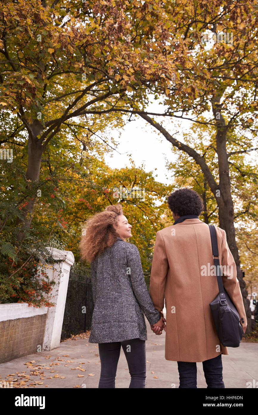 Rear View Of Romantic Couple Walking On Fall Street In City Stock Photo ...
