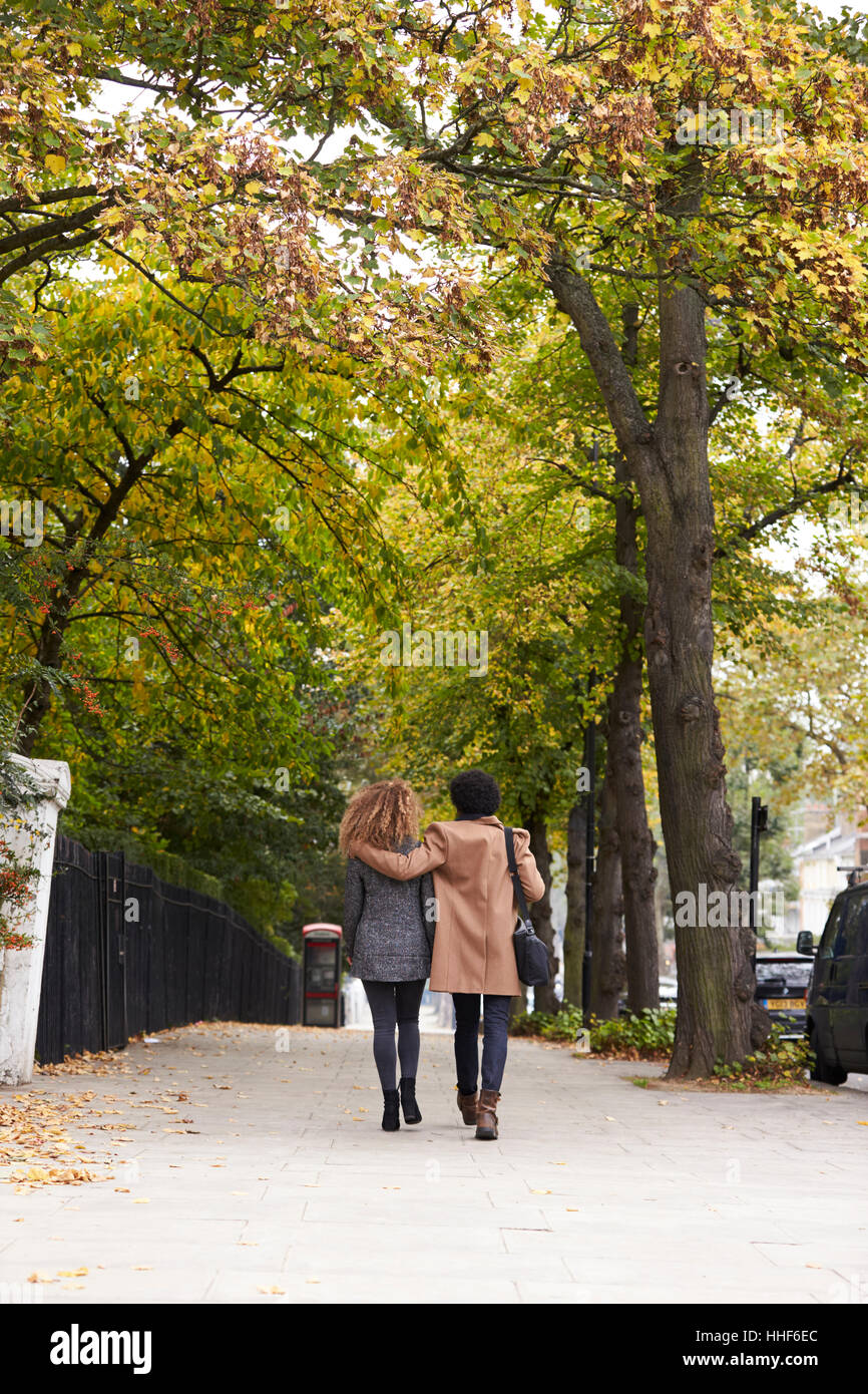 Rear View Of Romantic Couple Walking On Fall Street In City Stock Photo ...