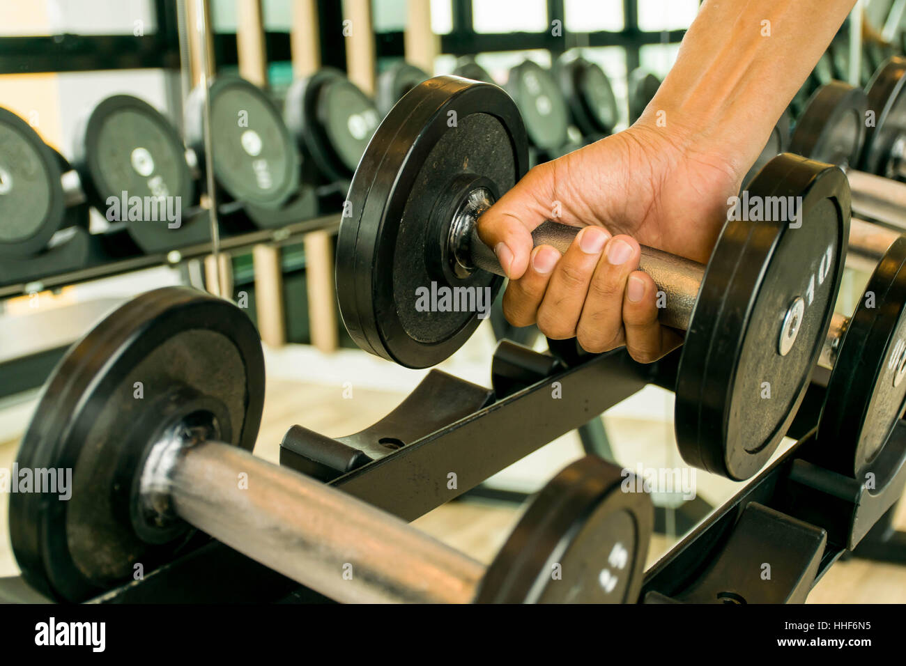 man is exercise in the gym with dumbbell Stock Photo - Alamy