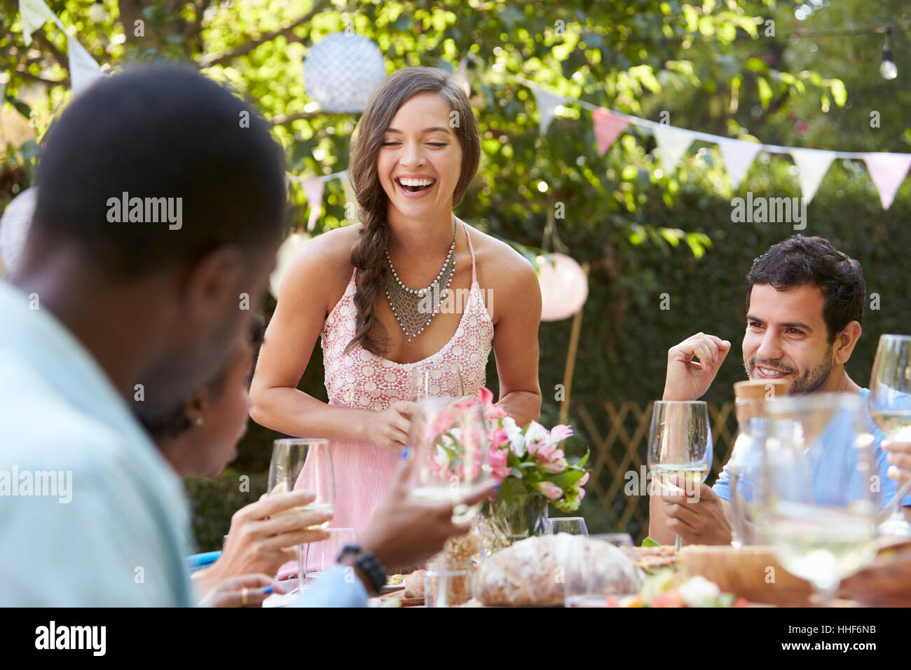 Woman Serving Food To Friends At Outdoor Backyard Party Stock Photo - Alamy