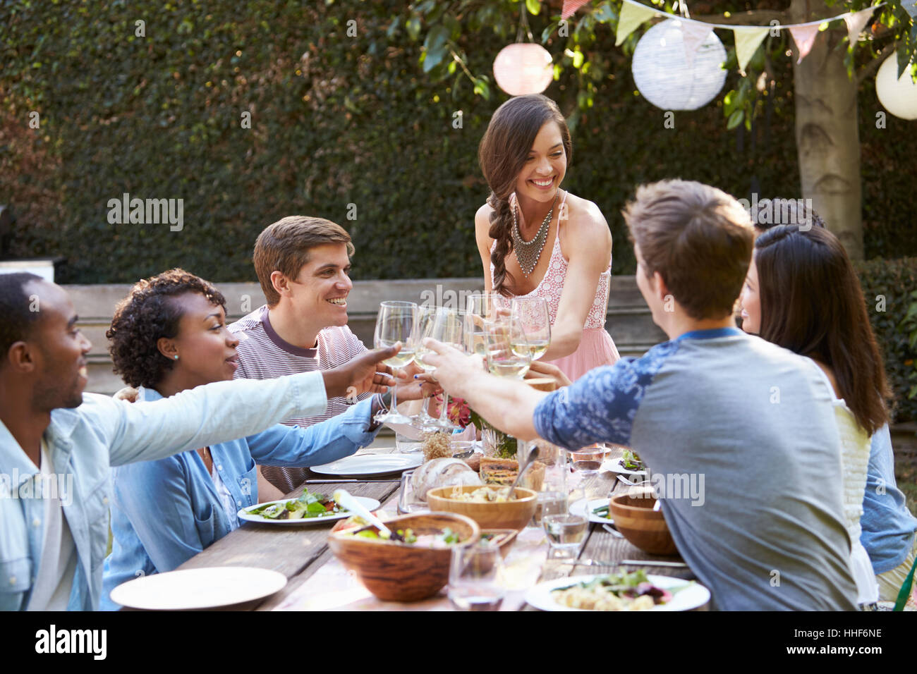 Friends Making A Toast At Outdoor Backyard Party Stock Photo - Alamy