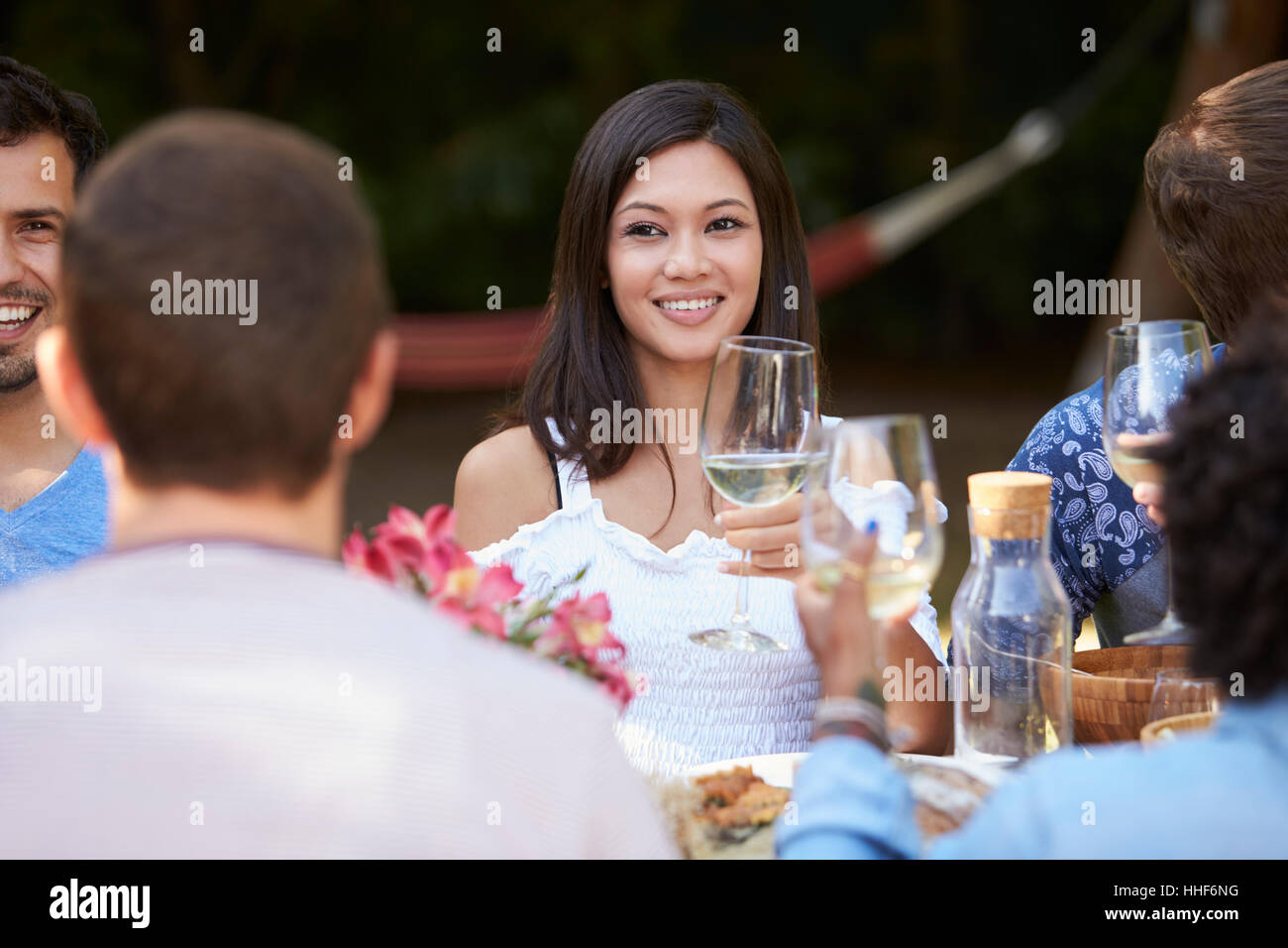 Young Woman Enjoying Outdoor Backyard Party With Friends Stock Photo ...