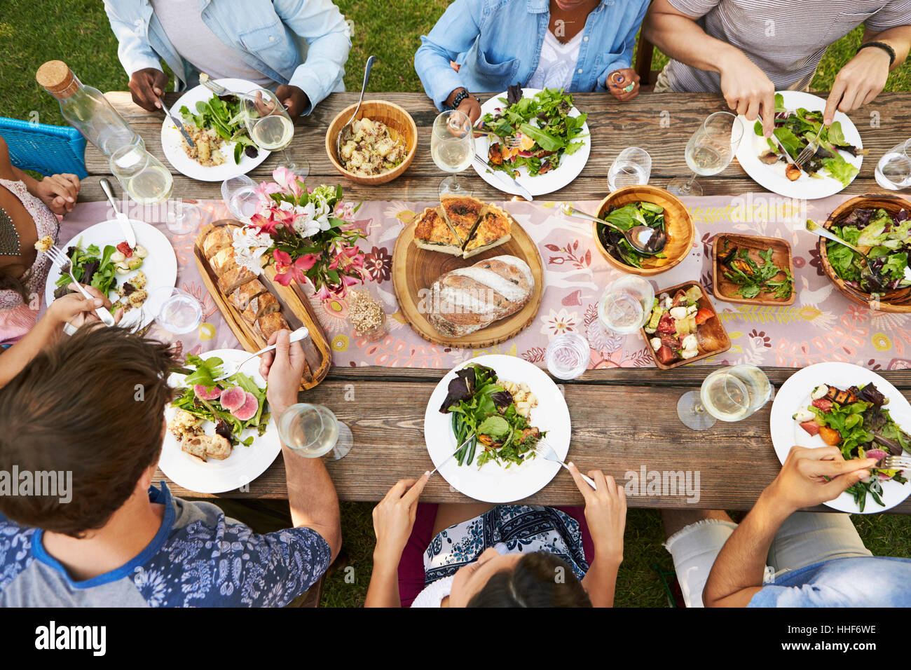 Overhead View Of Friends Eating And Drinking Around Table Stock Photo ...