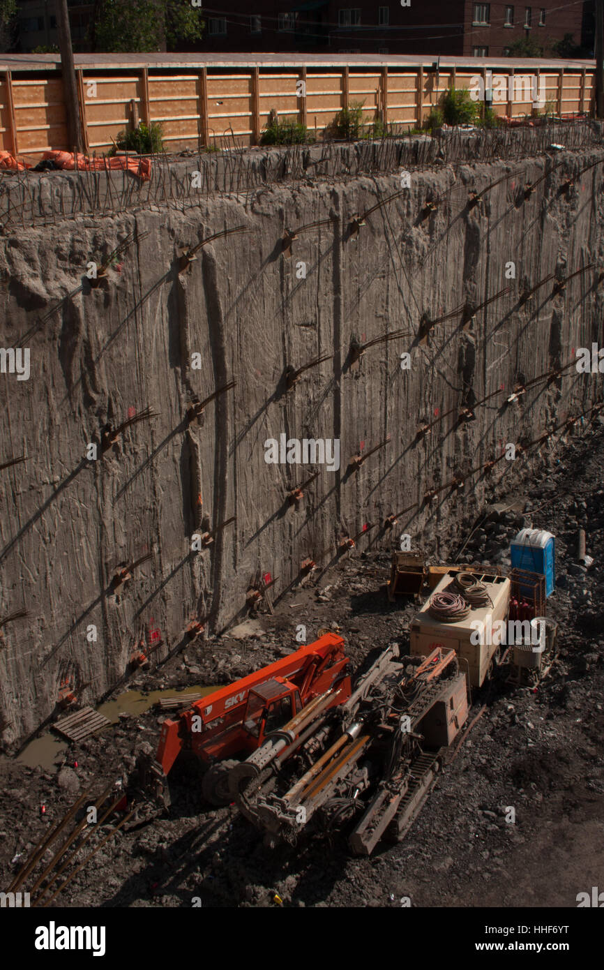 Construction trucks below ground in later afternoon sun Stock Photo - Alamy