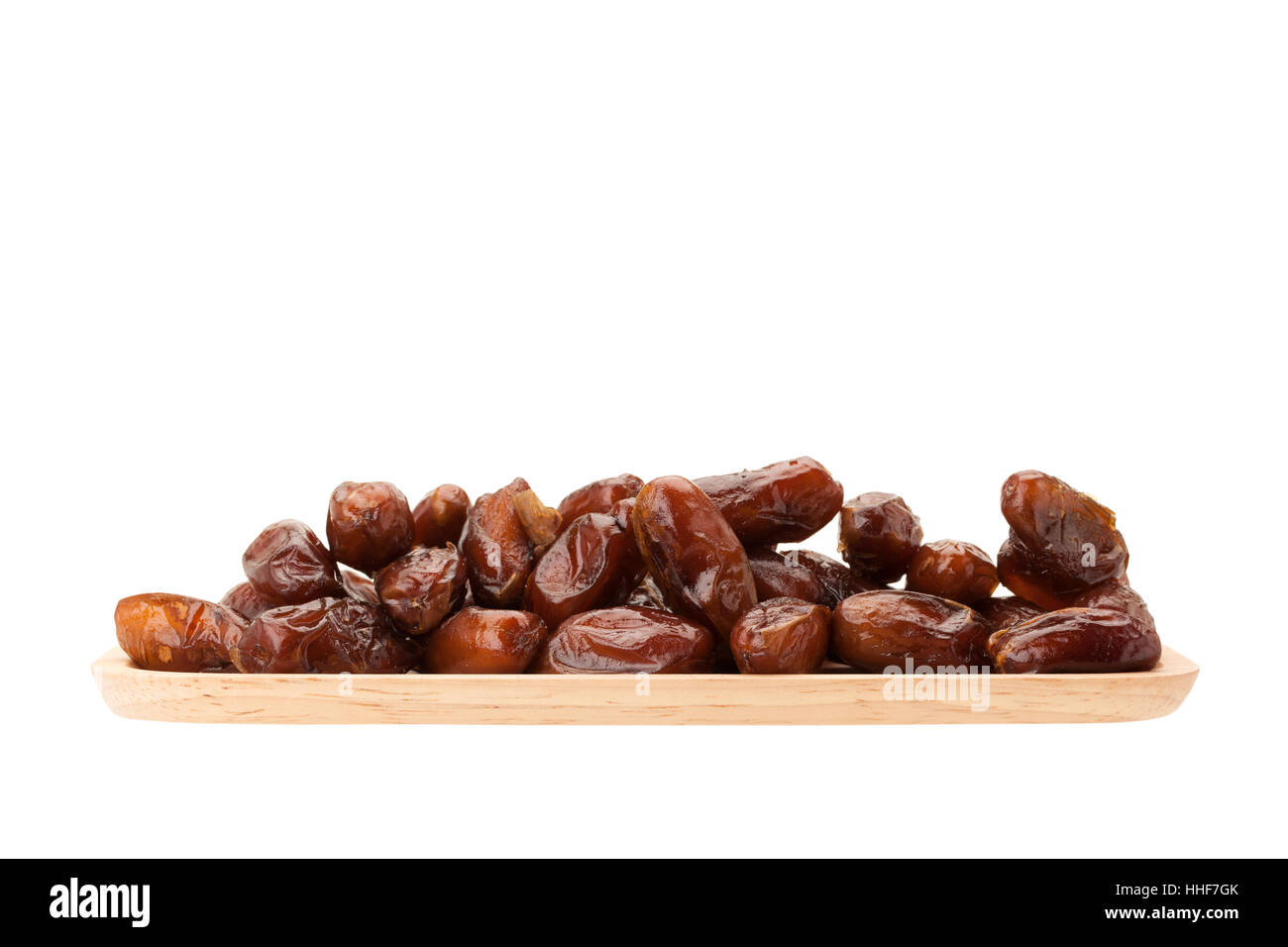 date palm dried fruit in wooden plate isolated on white background with ...