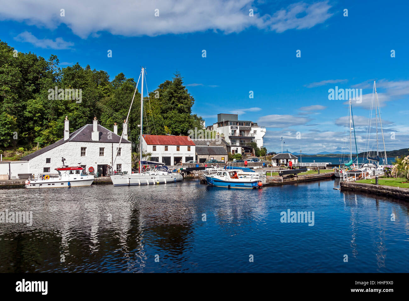 A yacht has entered the Crinan Canal basin at Crinan in Knapdale Argyll ...