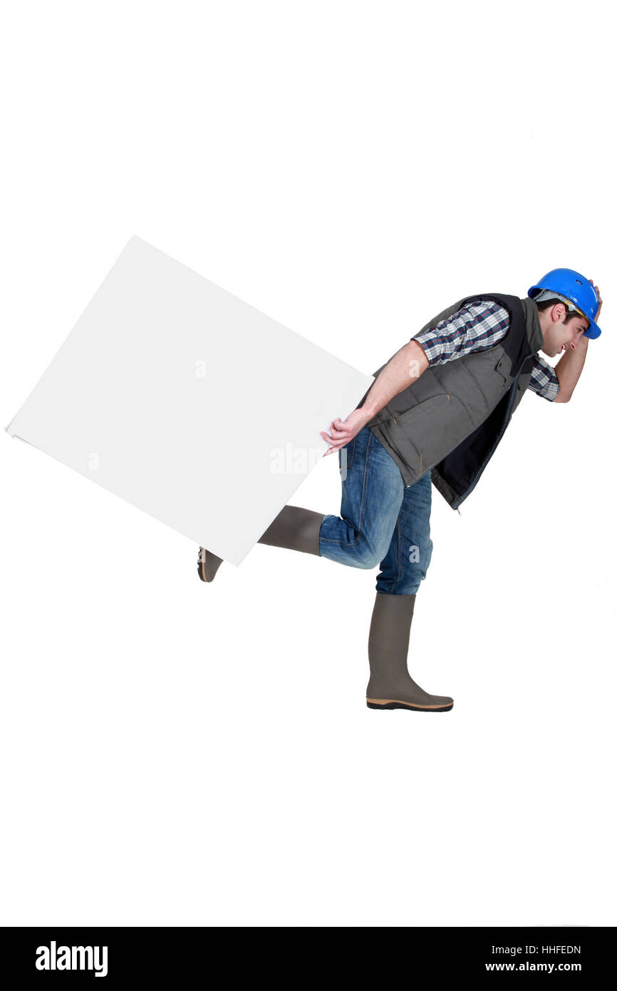 Builder running away with poster Stock Photo - Alamy