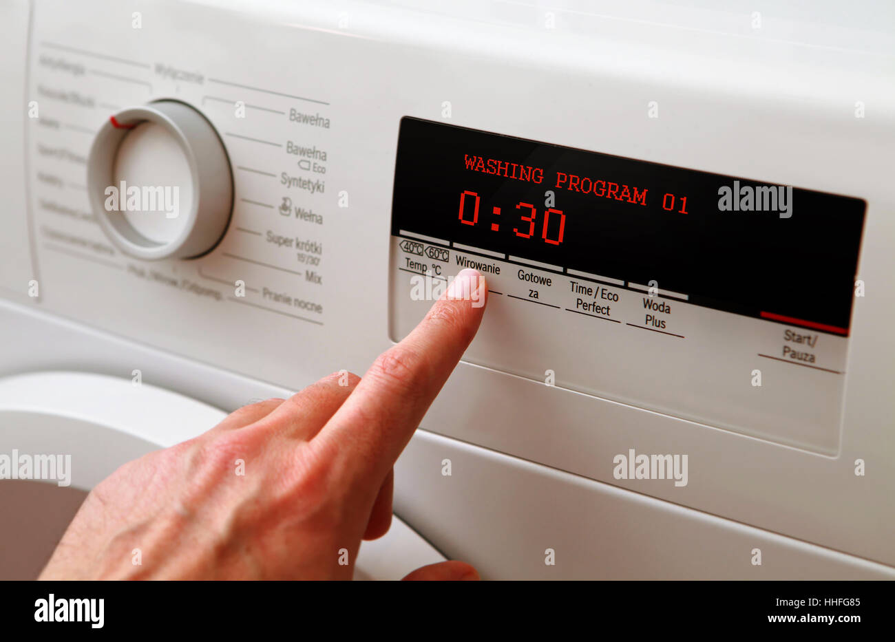 Close up of man hand adjusting washing machine Stock Photo - Alamy