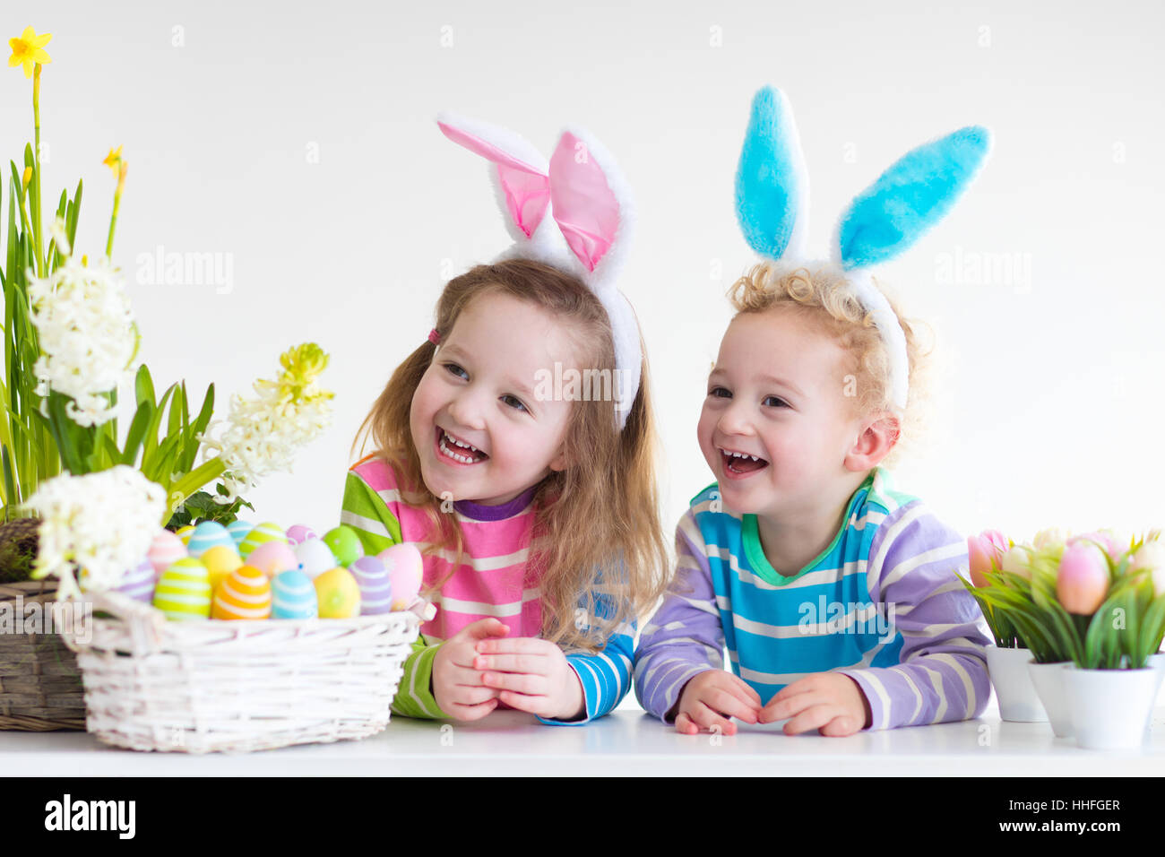 Happy children celebrate Easter at home. Boy and girl wearing bunny ...