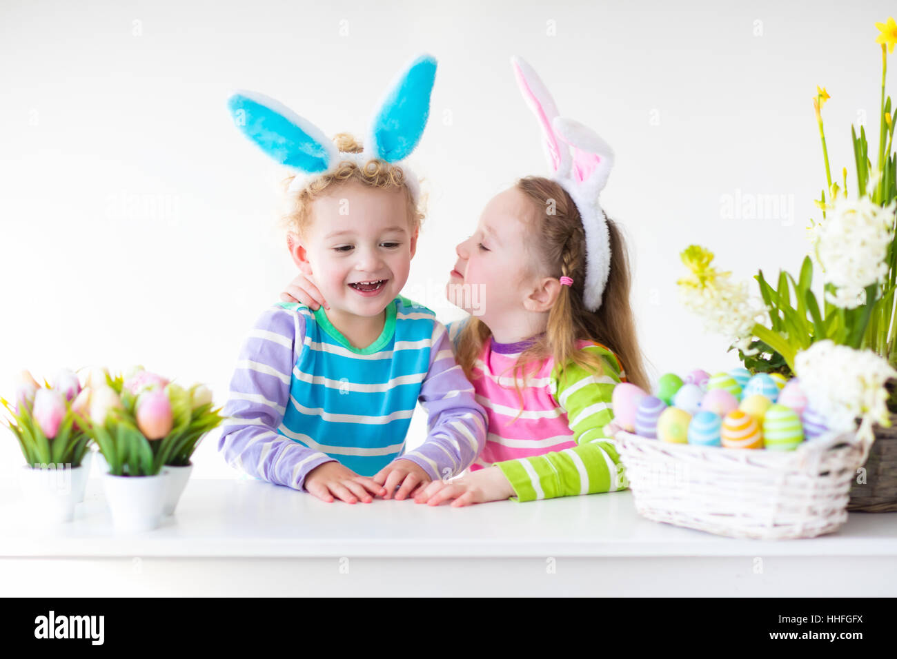 Happy children celebrate Easter at home. Boy and girl wearing bunny ...