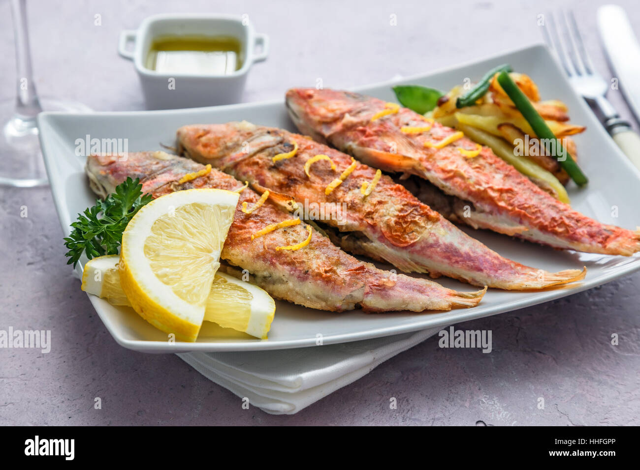 Grilled red mullets on square plate selective focus on front Stock ...