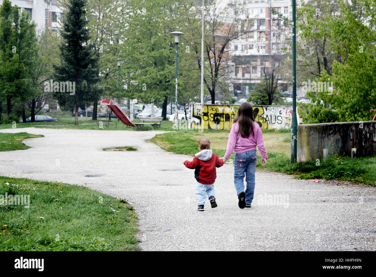 2 Kids walking on Park Stock Photo - Alamy