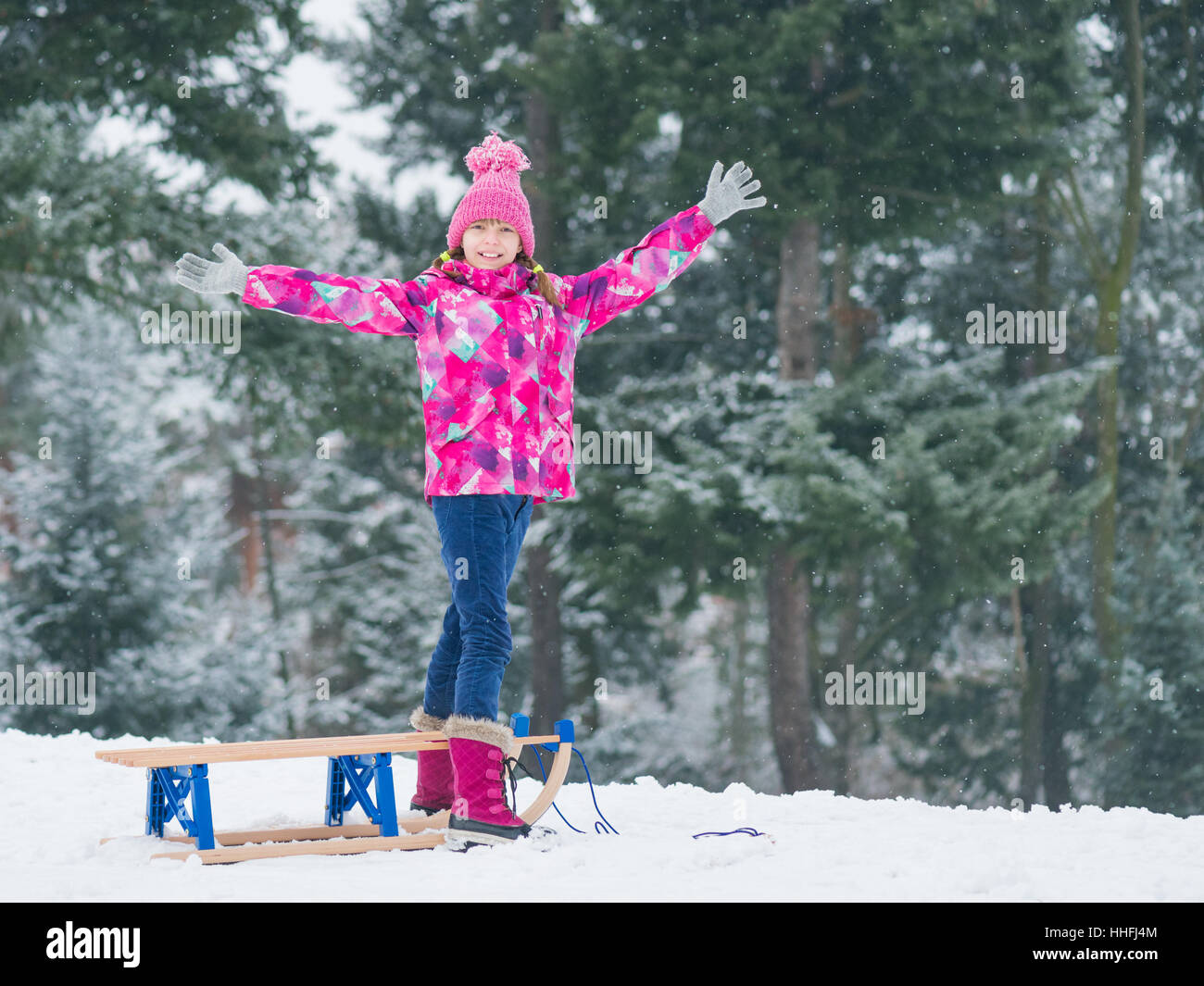 Child play in snow with sled Stock Photo - Alamy
