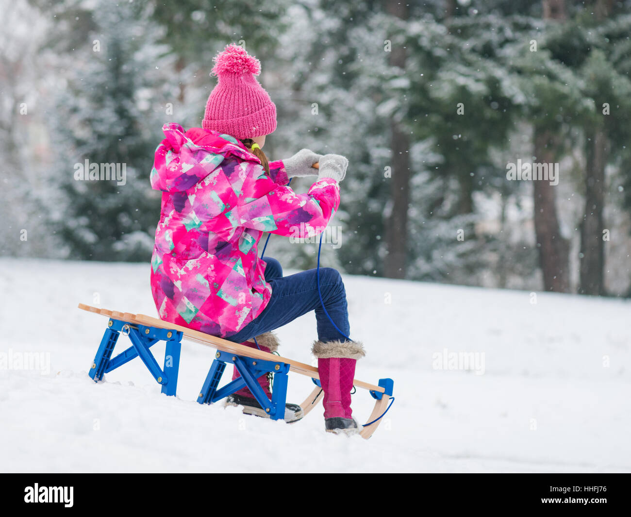 Child play in snow with sled Stock Photo - Alamy