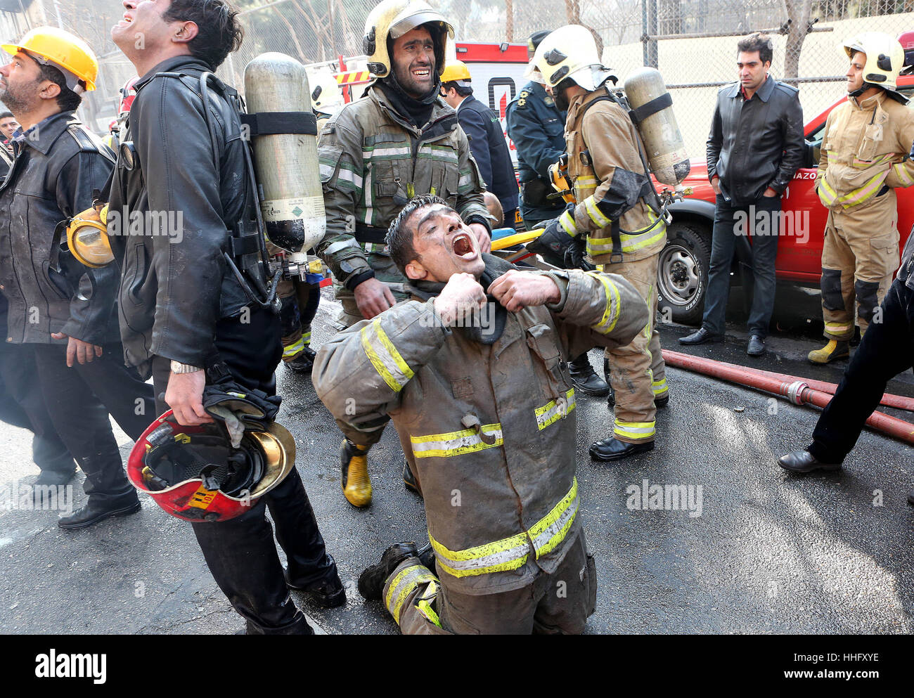 Tehran, Iran. 19th Jan, 2017. Iranian firefighters mourn beside a ...