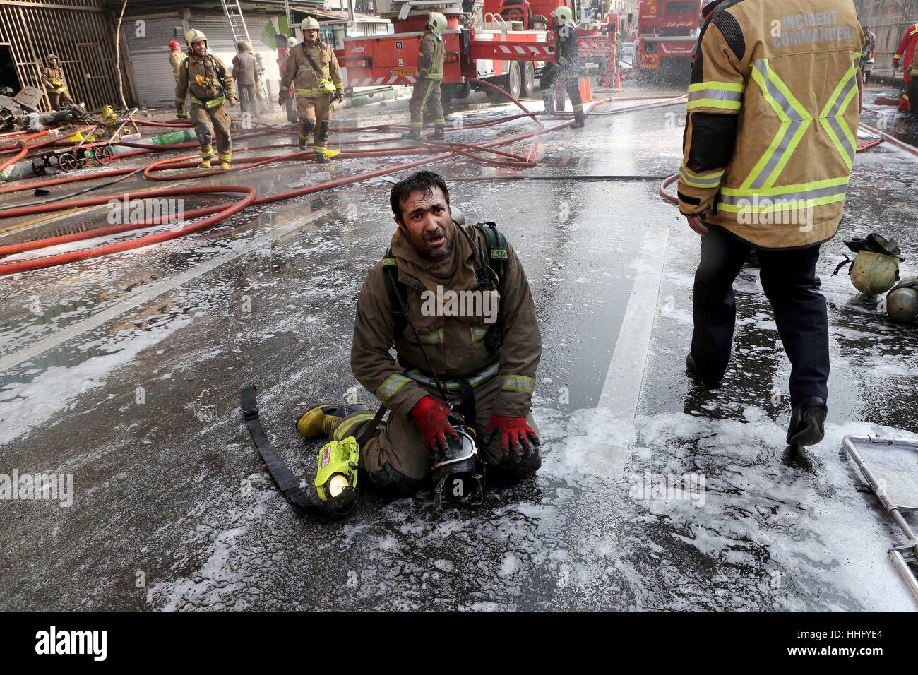 Tehran, Iran. 19th Jan, 2017. An Iranian firefighter mourns beside a ...