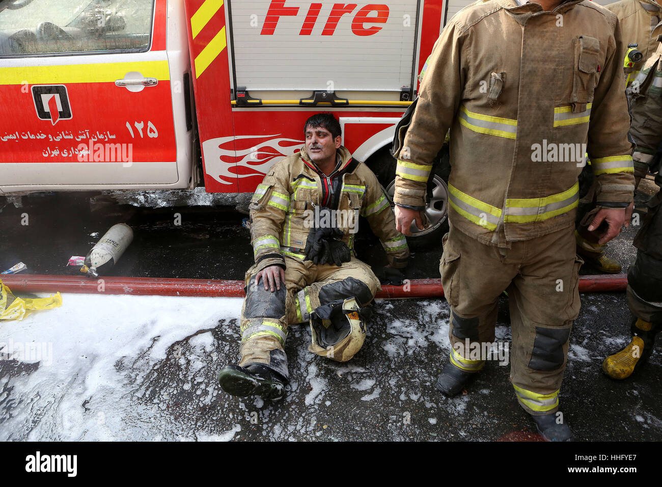 Tehran, Iran. 19th Jan, 2017. An Iranian firefighter cries in front of ...