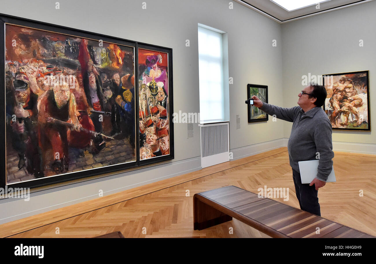 A journalist takes a photo of the painting 'Die Straße der Kommune' by ...