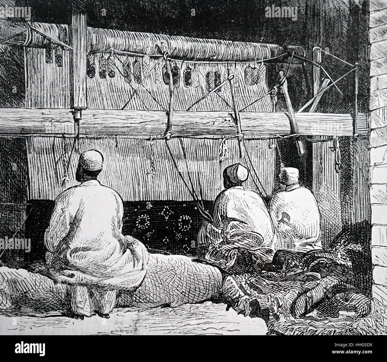 Convicts are shown seated making carpets in the prison at Peshawar ...