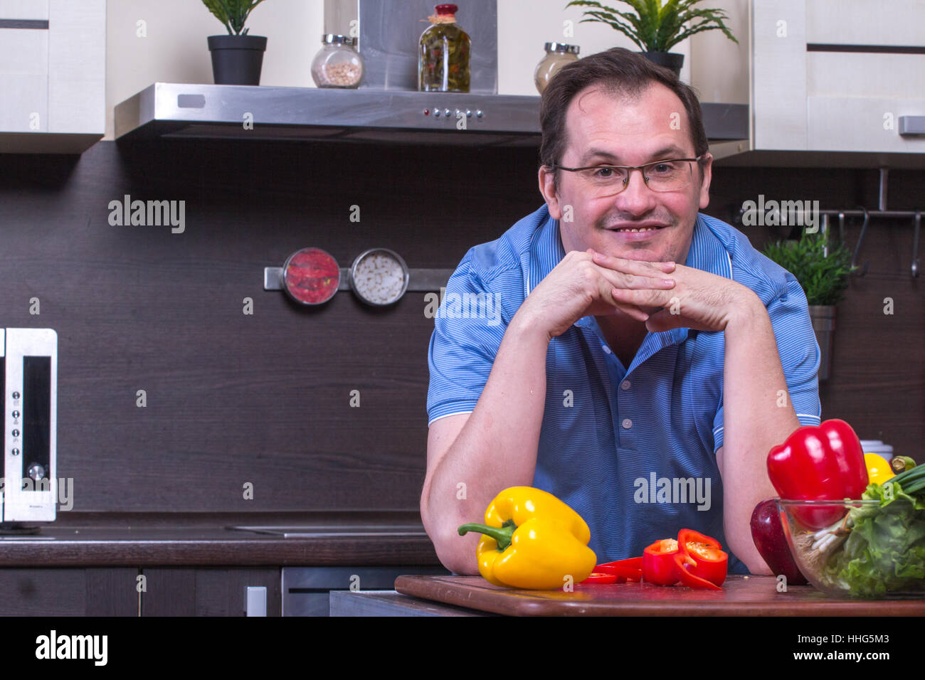 Portrait of adult sad man cooking in the kitchen, problem prepare ...