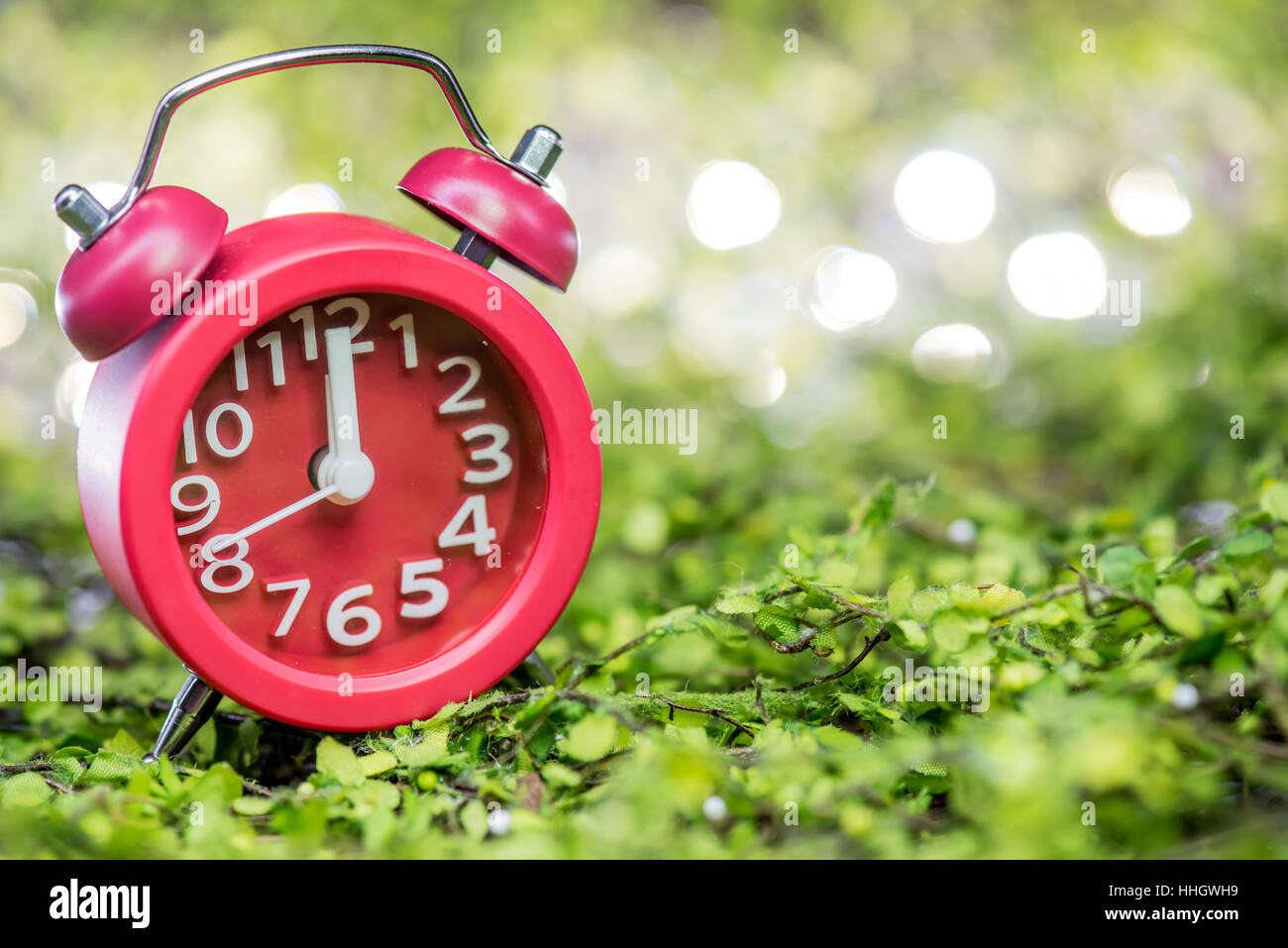 Red clock at midnight time Stock Photo - Alamy