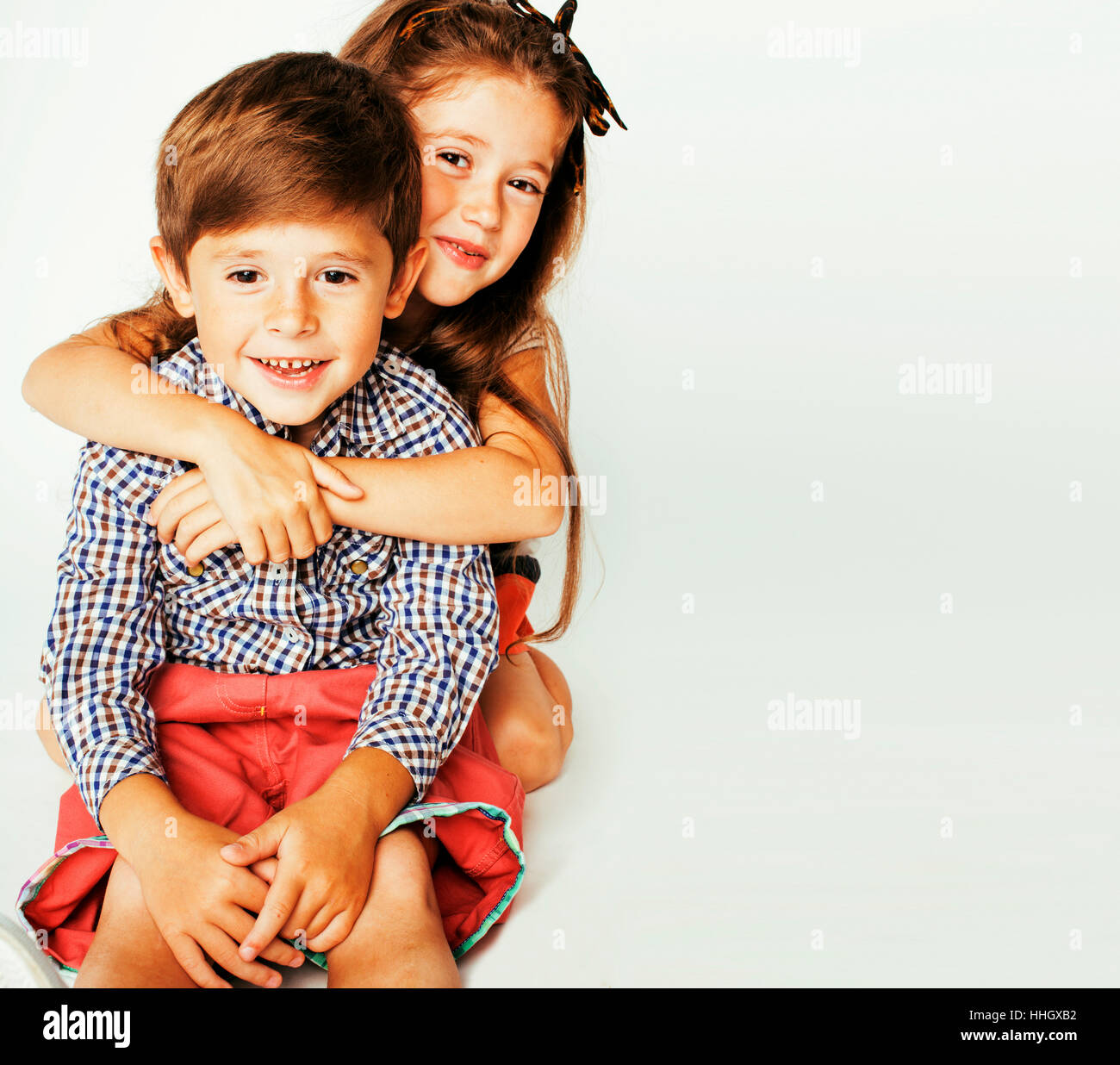 little cute boy and girl hugging playing on white background, ha Stock Photo - Alamy
