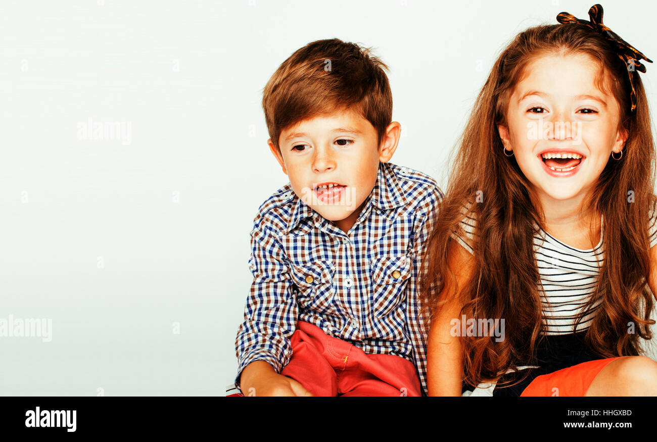 little cute boy and girl hugging playing on white background, ha Stock Photo - Alamy