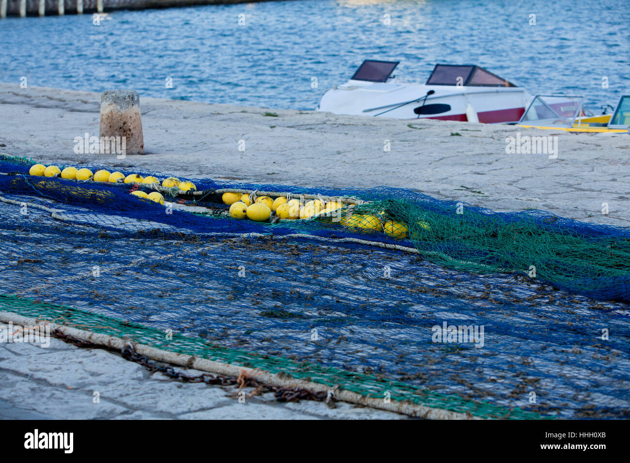 fishing net with linen and ropes on ship at the quay at the port in ...