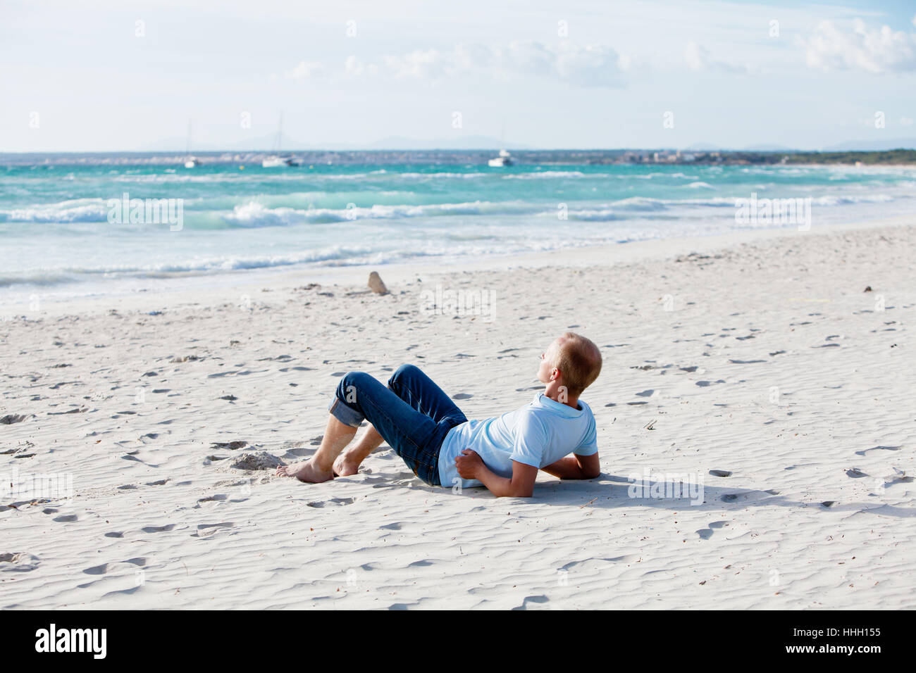young man relaxing at the beach at the water in summer Stock Photo - Alamy