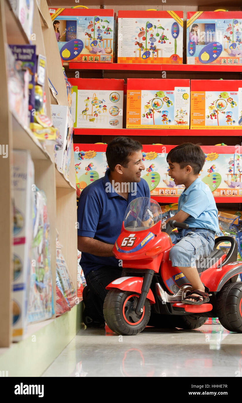 father and son in toy store Stock Photo - Alamy