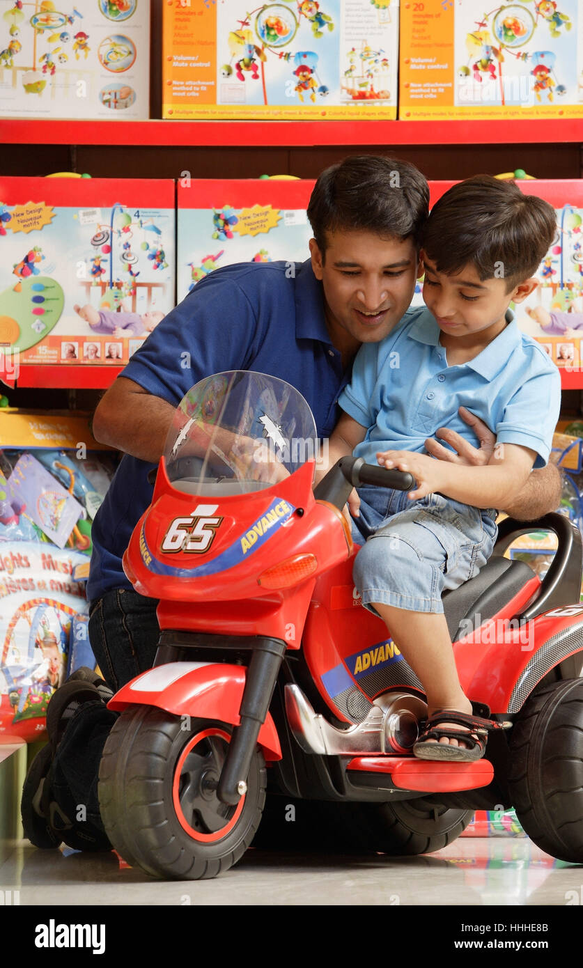 father and son in toy store Stock Photo - Alamy