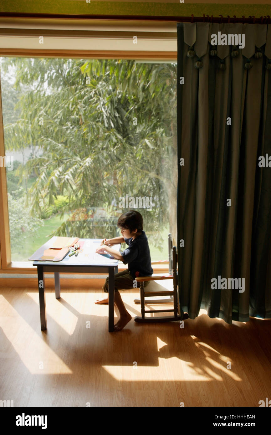 boy playing at table Stock Photo - Alamy