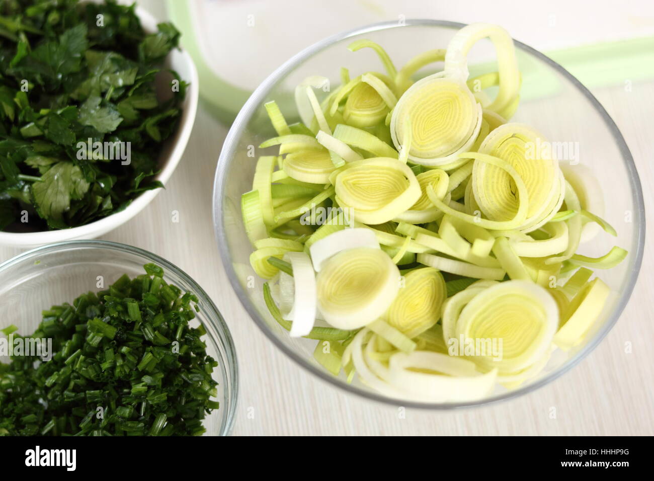 Sliced leek, minced parsley and chives in bowl. Making Potato and Leek ...