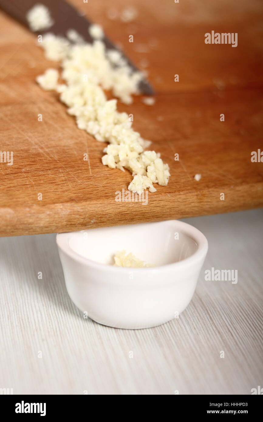 Adding minced garlic into bowl. Making Potato and Leek Filo Pie. Series ...