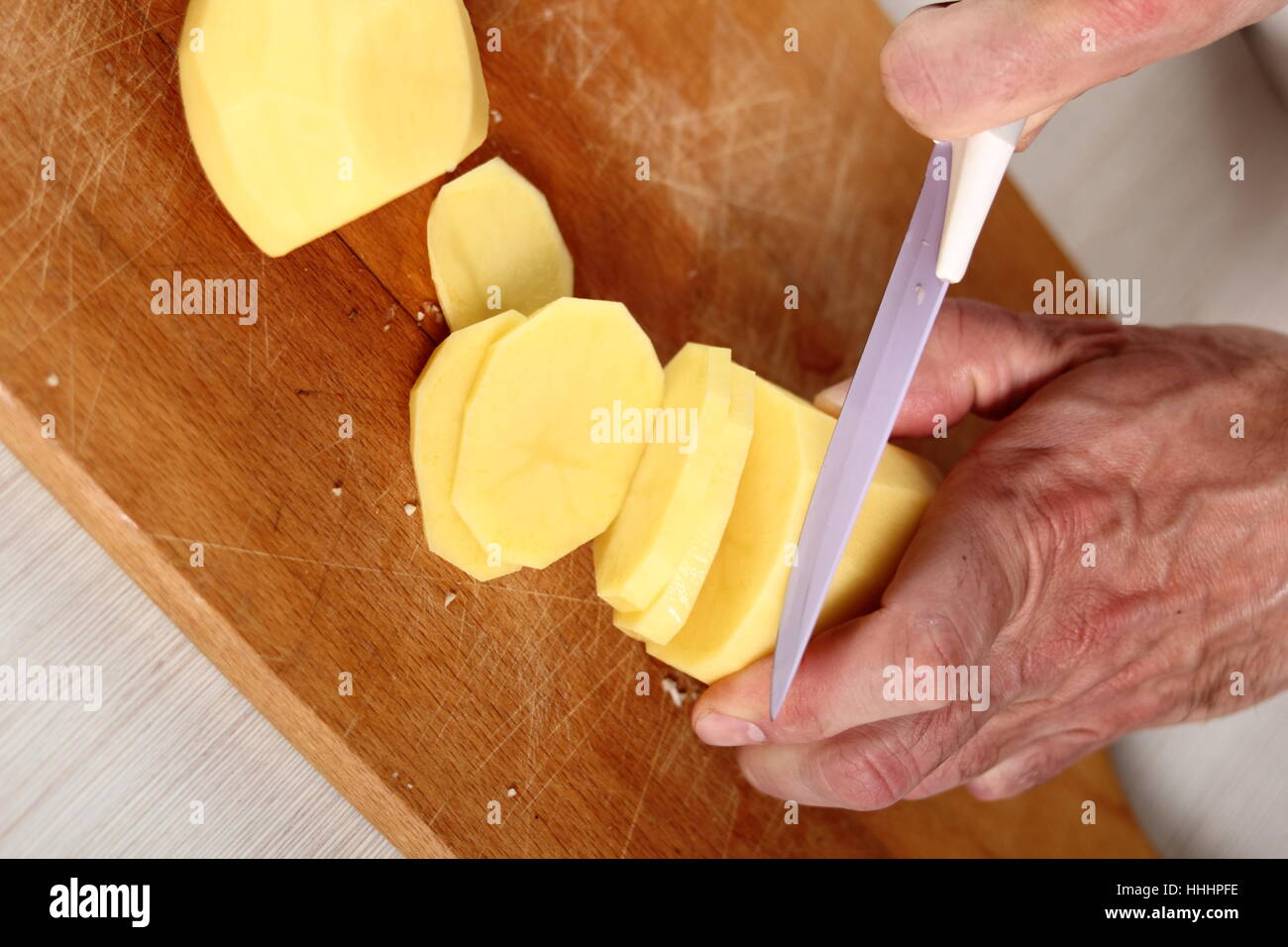 Slicing potato into circles. Making Potato and Leek Filo Pie. Series ...