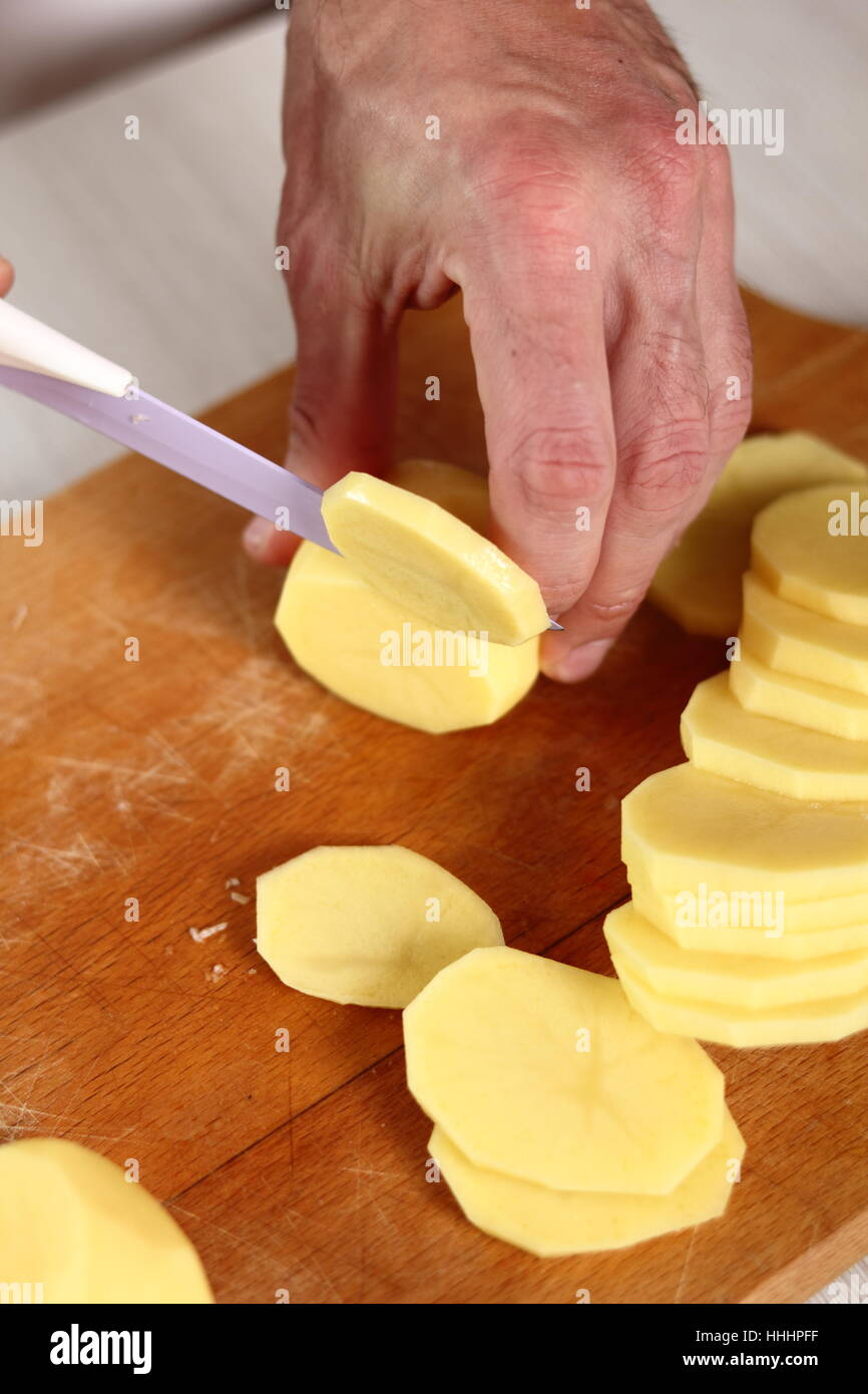 Slicing potato into circles. Making Potato and Leek Filo Pie. Series ...