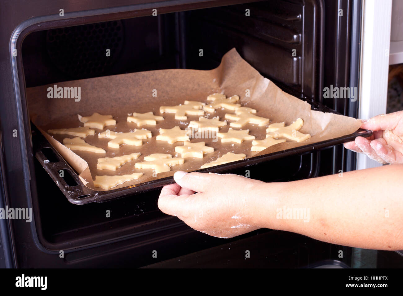 push the baking tray in the oven Stock Photo - Alamy
