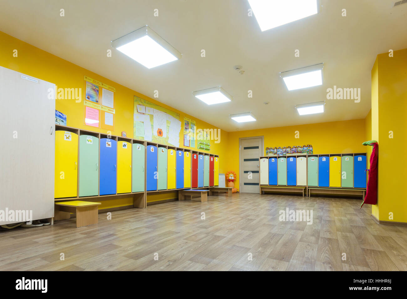 Yellow colored changing room and lockers of kindergarten for children ...
