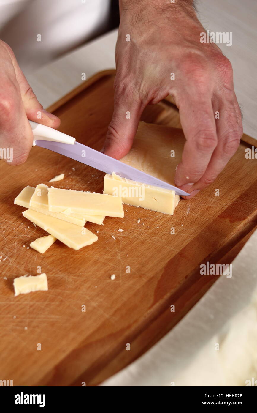 Slicing Cheddar cheese. Making Potato and Leek Filo Pie. Series Stock ...