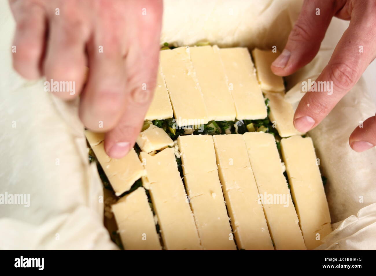 Layer cheese slices. Making Potato and Leek Filo Pie. Series Stock ...