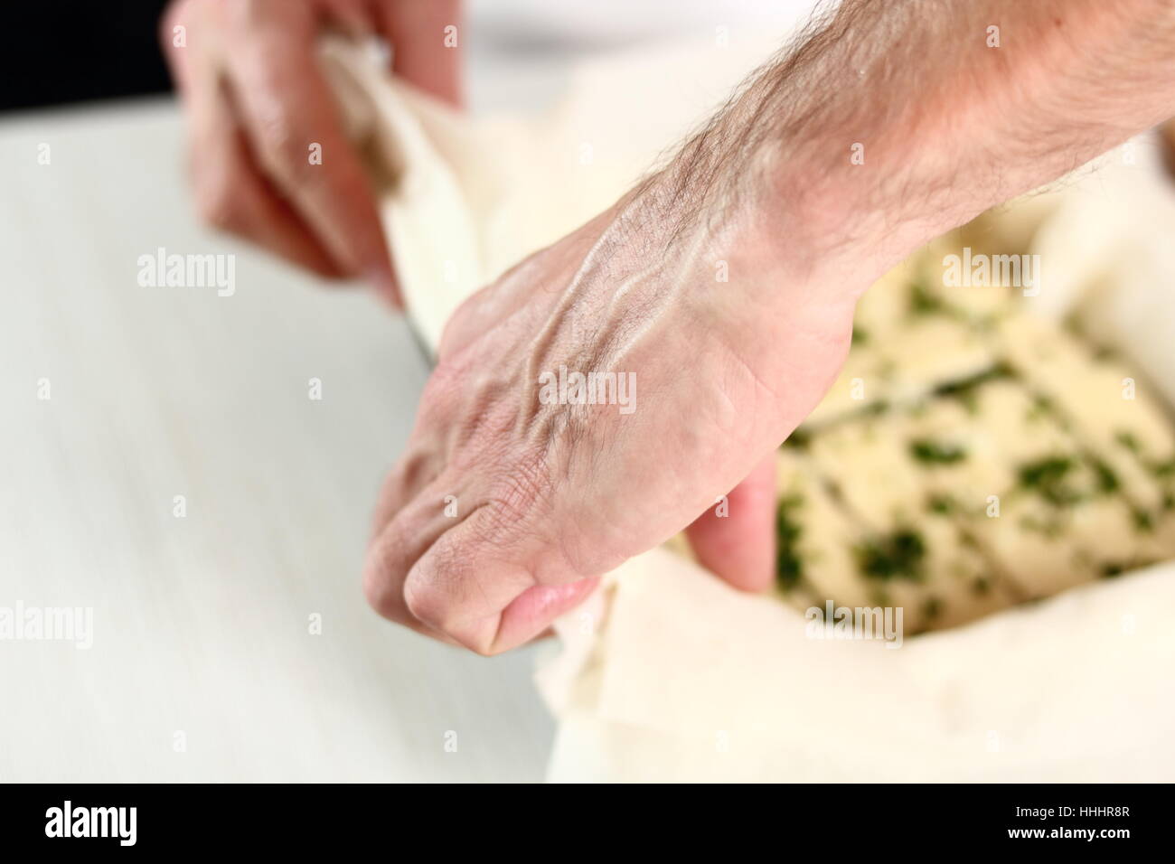 Fold pastry over filling. Making Potato and Leek Filo Pie. Series Stock ...