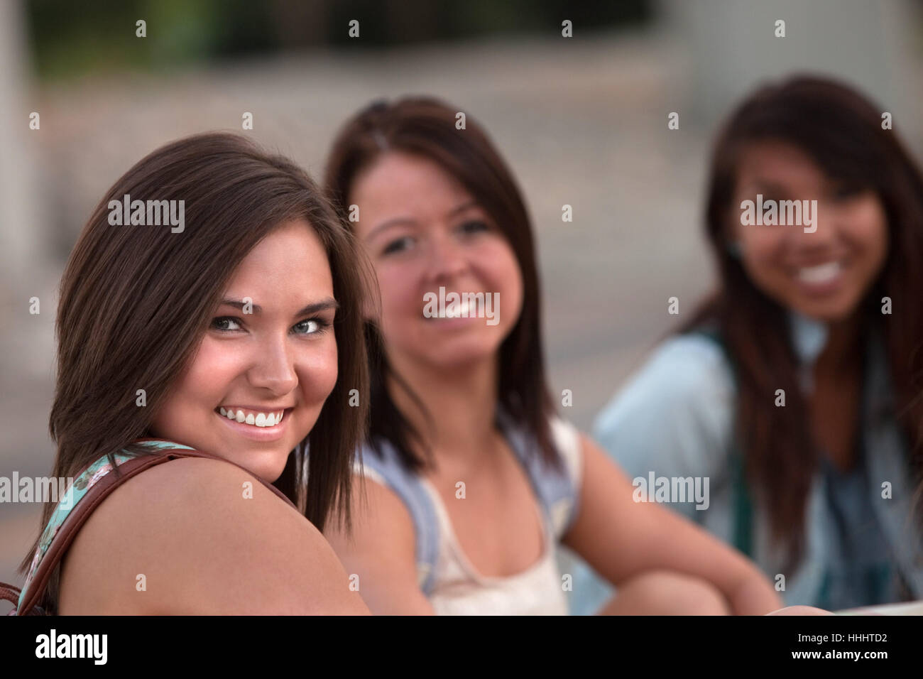 Group of three Asian and European teenage girls sitting Stock Photo - Alamy