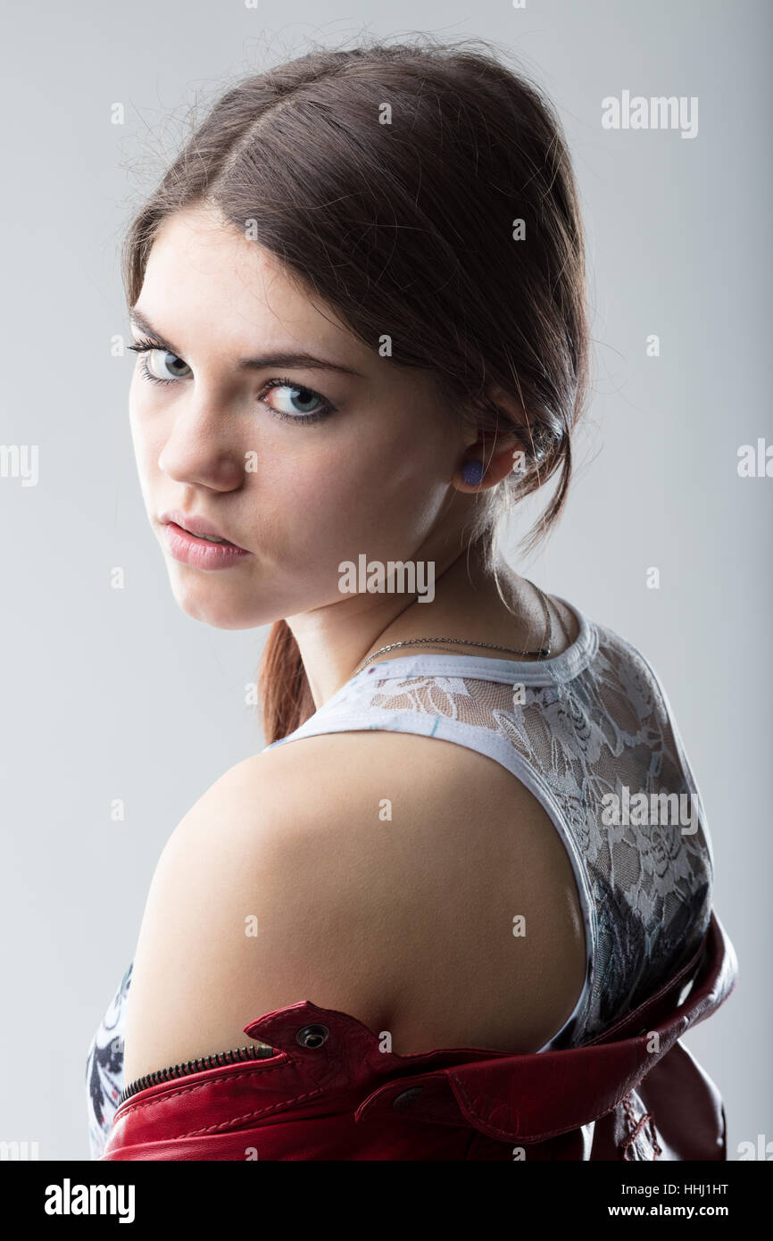 intense look of a model girl posing with a red jacket Stock Photo - Alamy