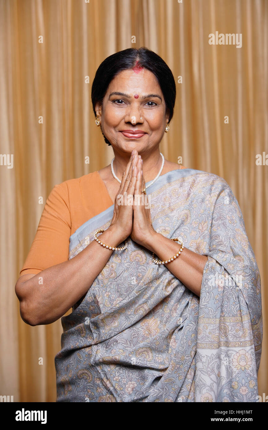 portrait of woman in namaste greeting gesture Stock Photo - Alamy
