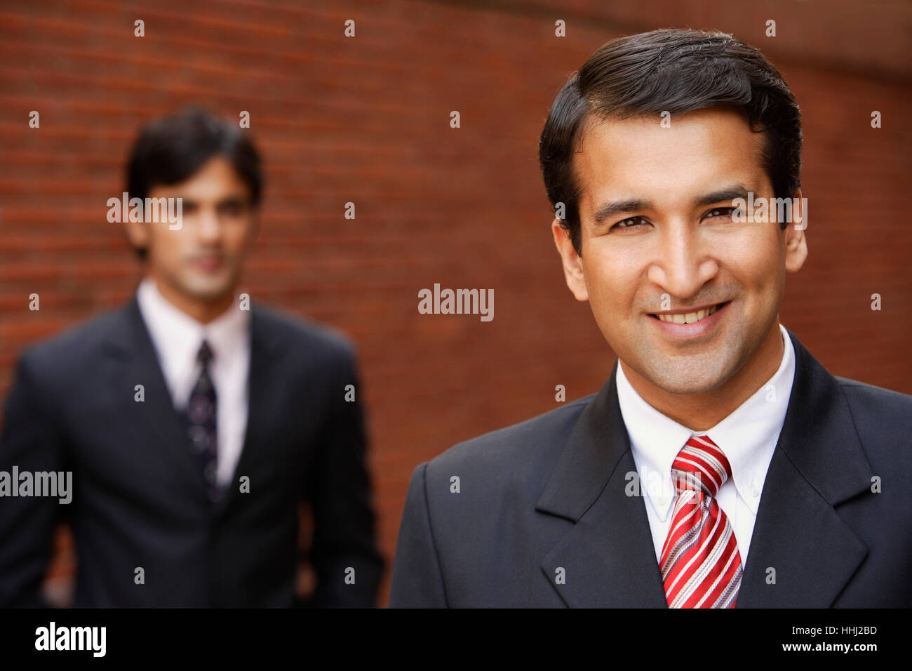 two businessmen, one smiling Stock Photo - Alamy