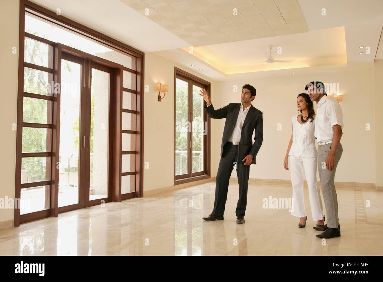 agent with young couple Stock Photo - Alamy