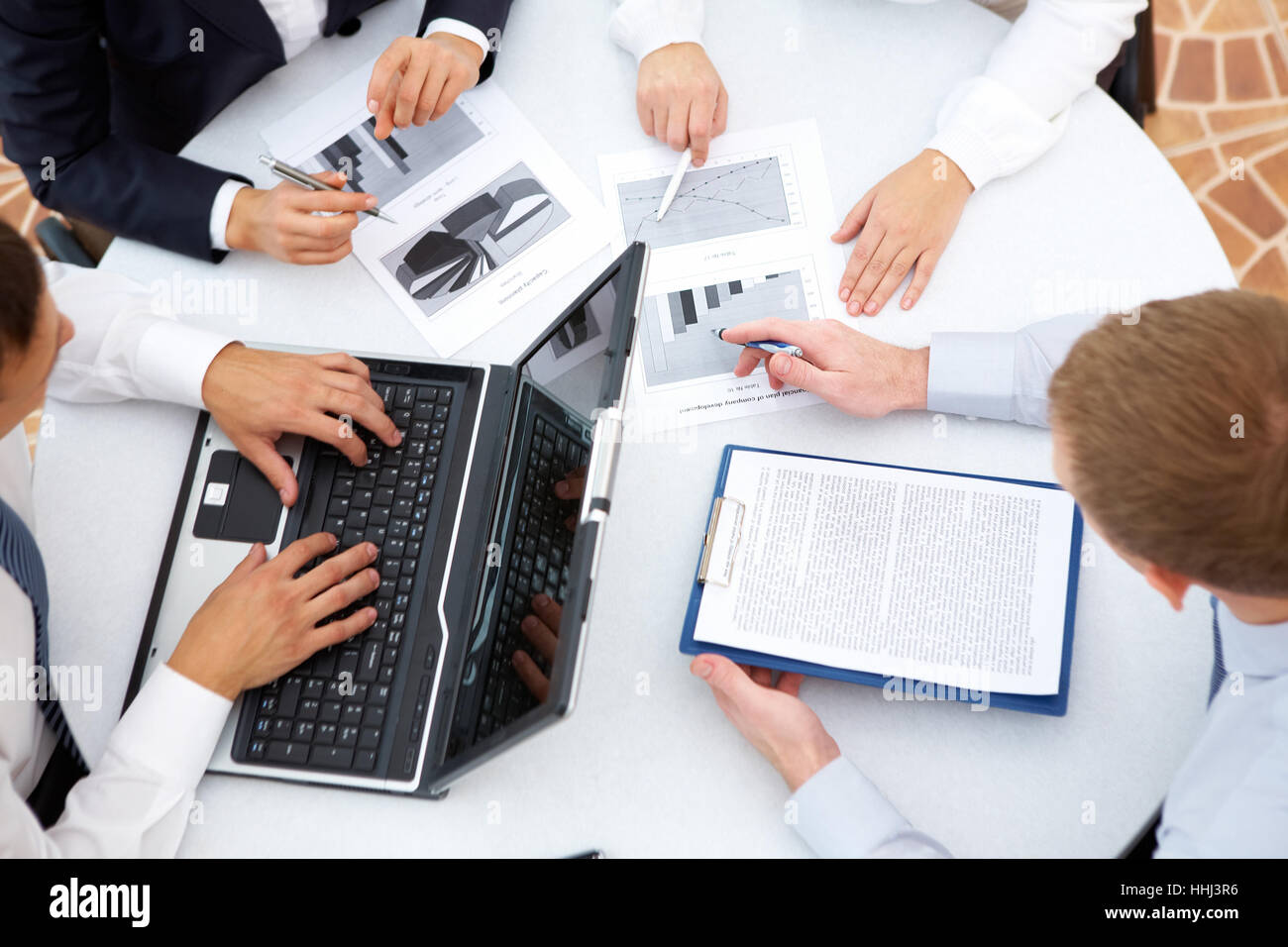 Overview of business people discussing diagrams Stock Photo - Alamy