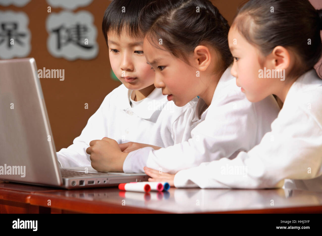 Young students using laptop in class Stock Photo - Alamy