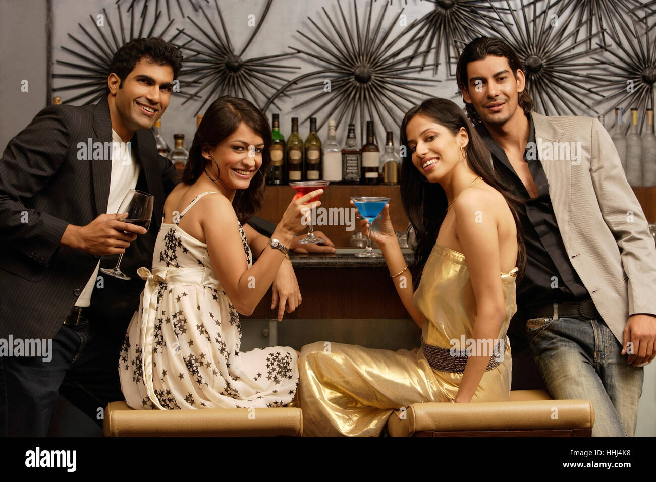 two couples in a bar Stock Photo - Alamy